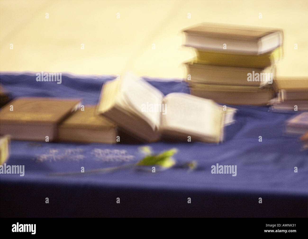 Stack of religious books with olive branch, blurry Stock Photo - Alamy