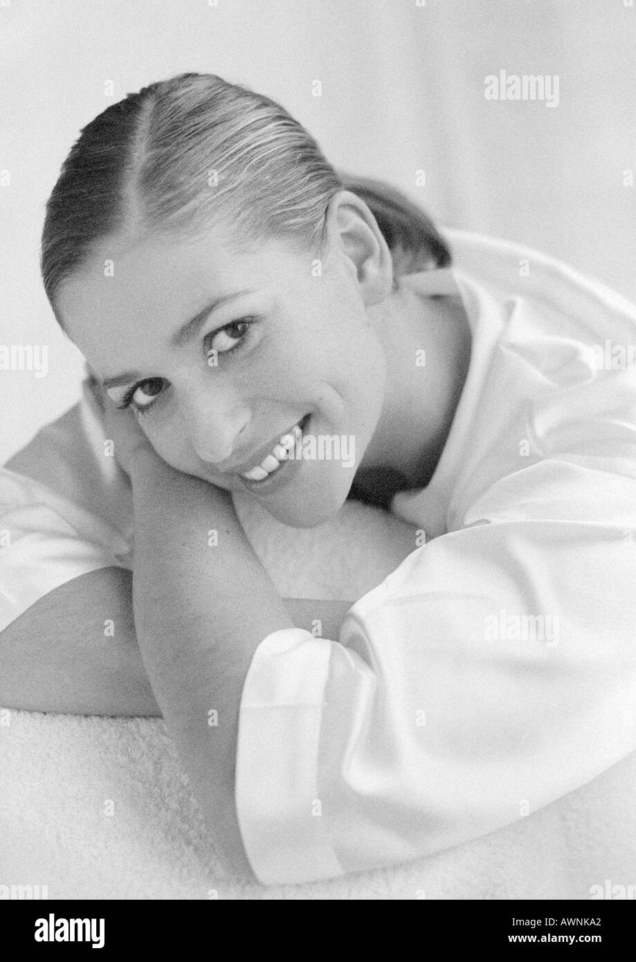 Woman leaning head on arms, smiling at camera, B&W Stock Photo - Alamy