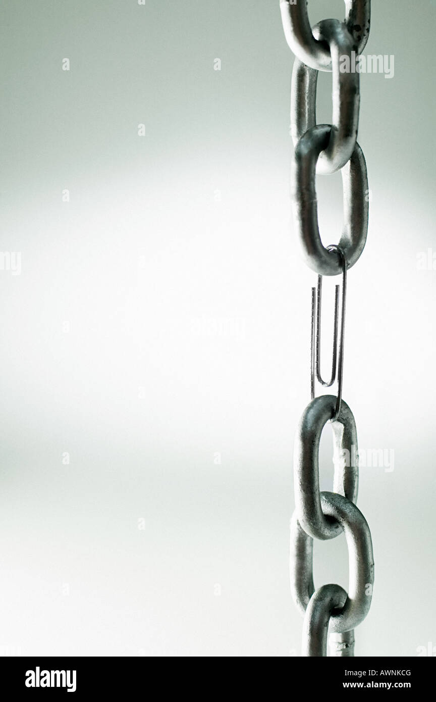 A paper clip in a metal chain Stock Photo - Alamy