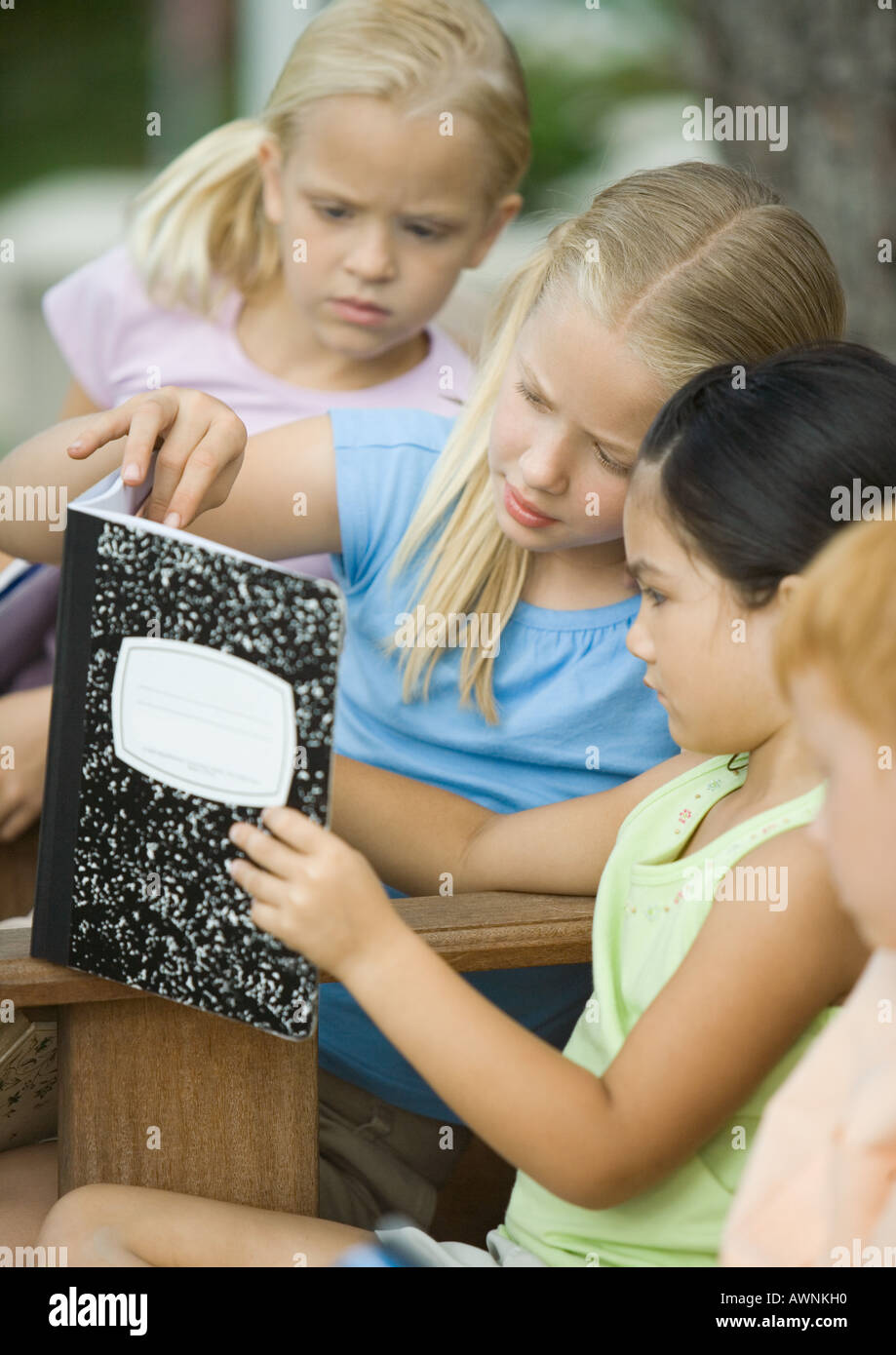 Group of children looking at notebook together Stock Photo - Alamy