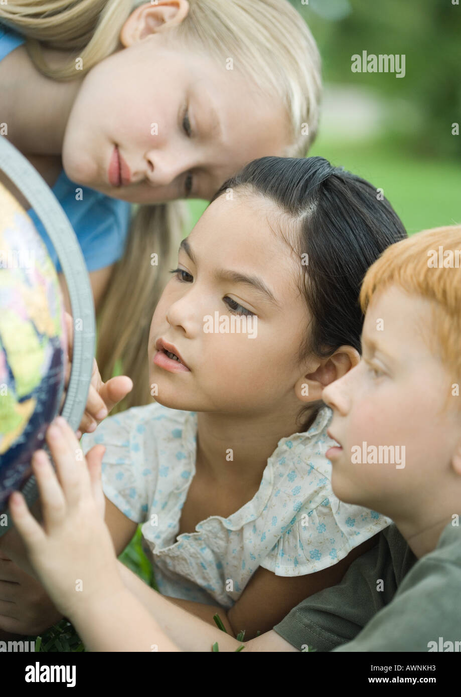 Children looking at globe Stock Photo - Alamy