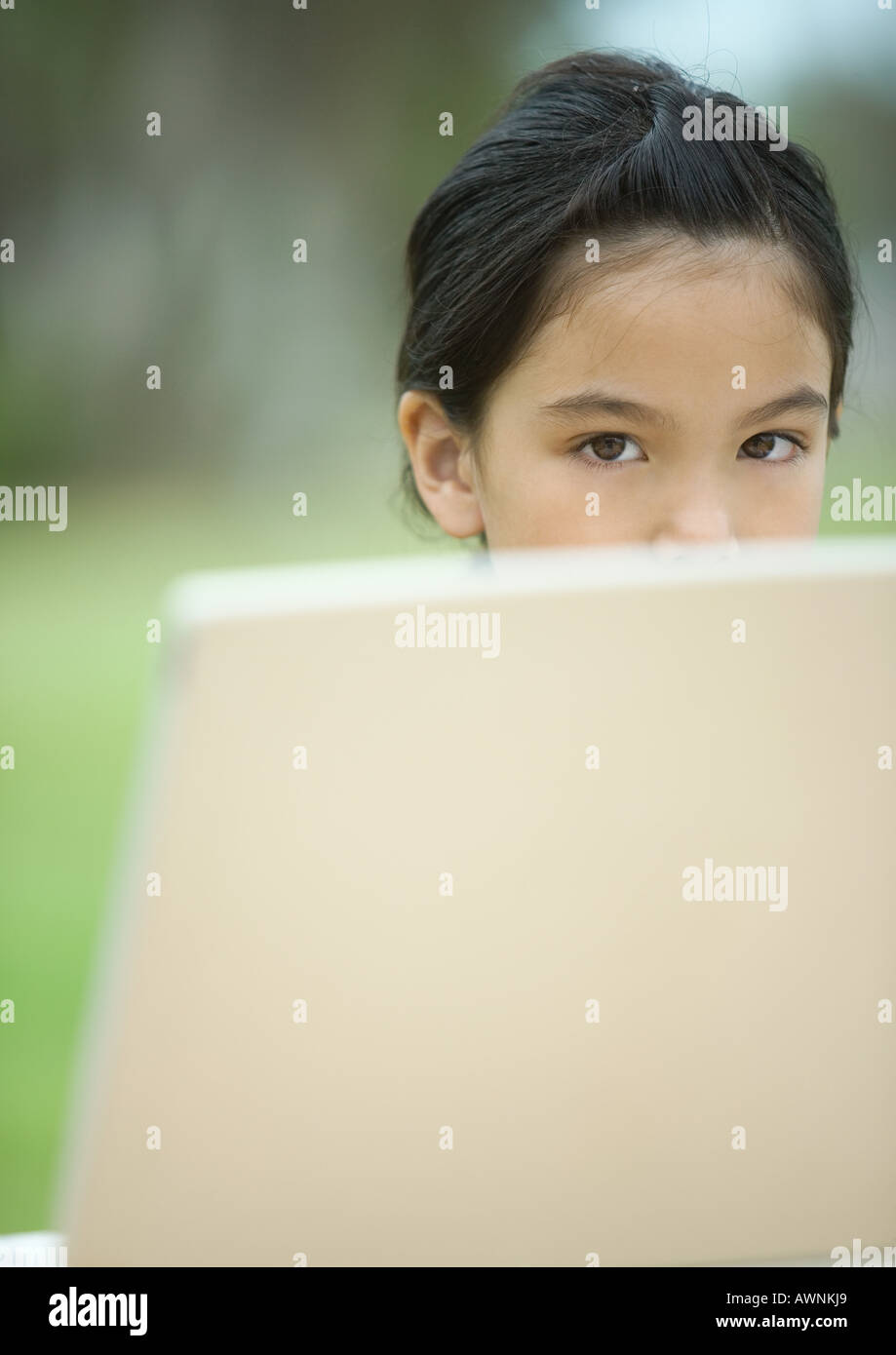 Girl's face, partially obscured by foreground Stock Photo - Alamy