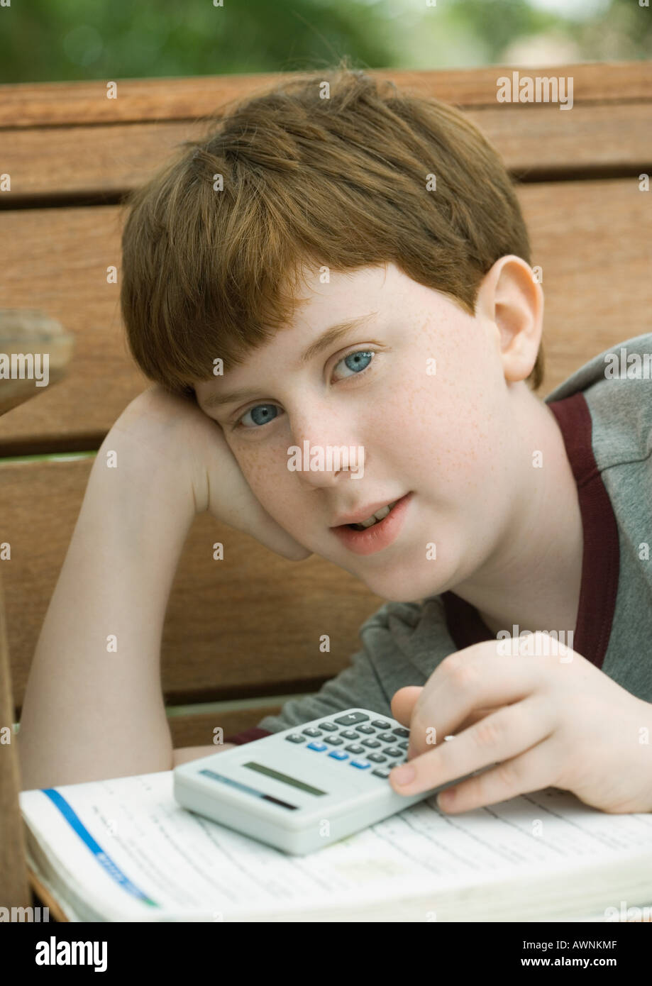 Boy with calculator and school book Stock Photo - Alamy