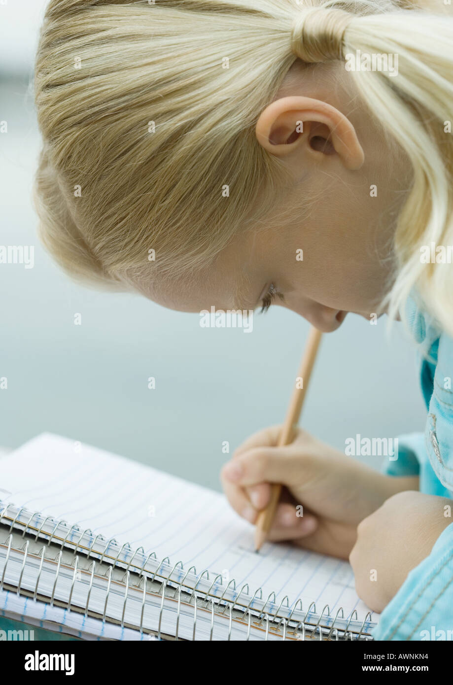 Young girl child head down writing hi-res stock photography and images ...