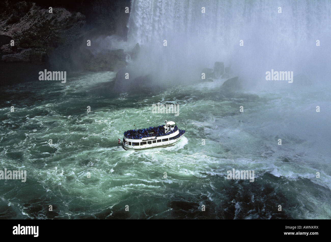 Maid of the Mist passenger boat. In mid river. Cascades of water. Mist ...