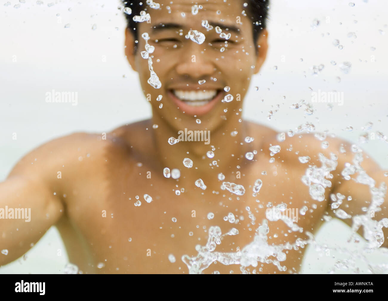 Man splashing in water Stock Photo - Alamy