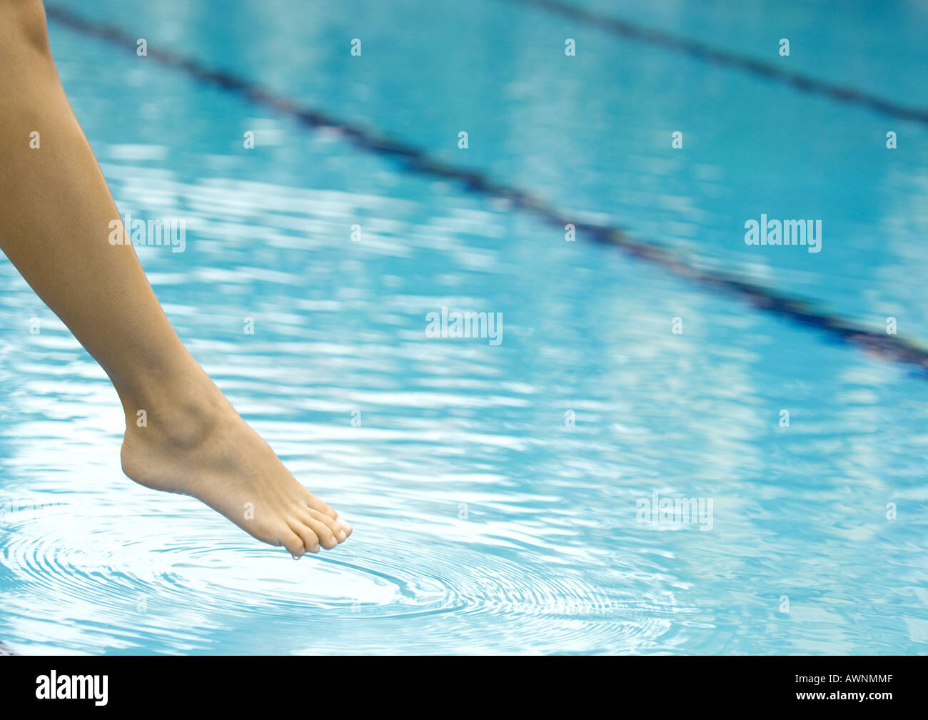Woman's leg testing water in pool Stock Photo - Alamy