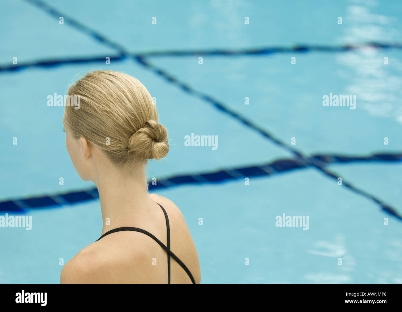 Woman facing pool, rear view Stock Photo - Alamy