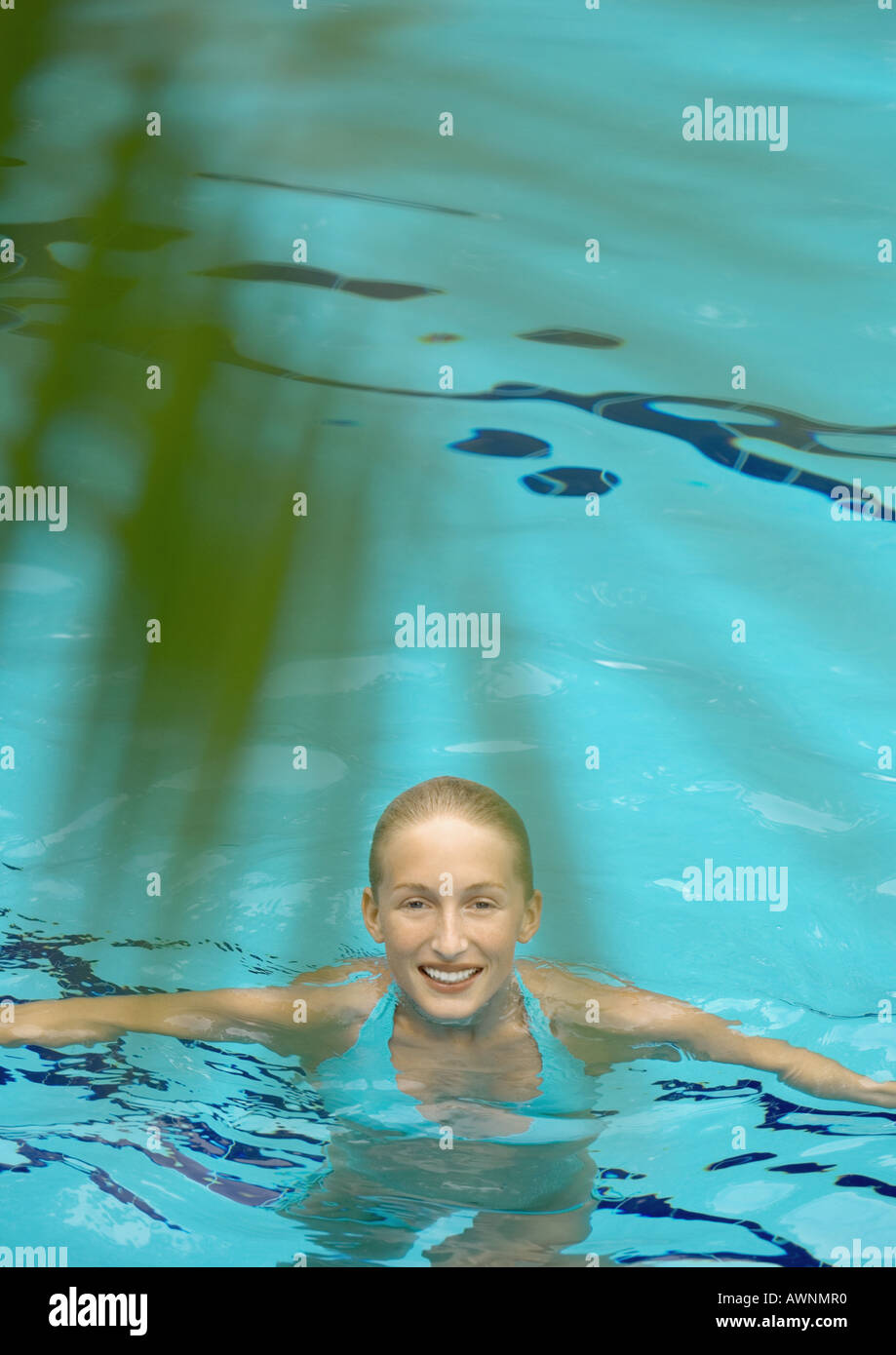 Woman in pool, smiling at camera Stock Photo - Alamy
