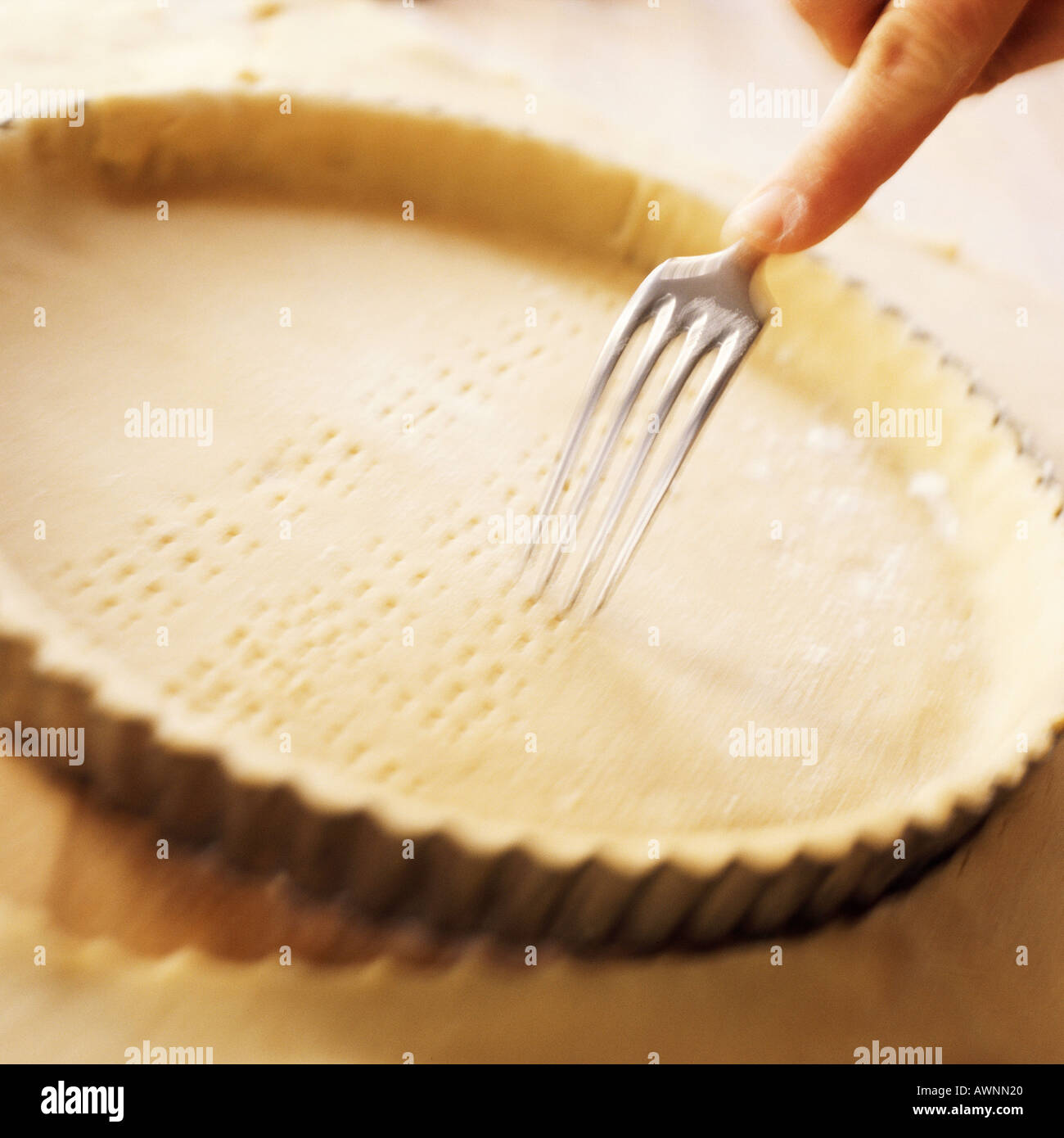Making marks in pie crust with fork, blurry Stock Photo - Alamy