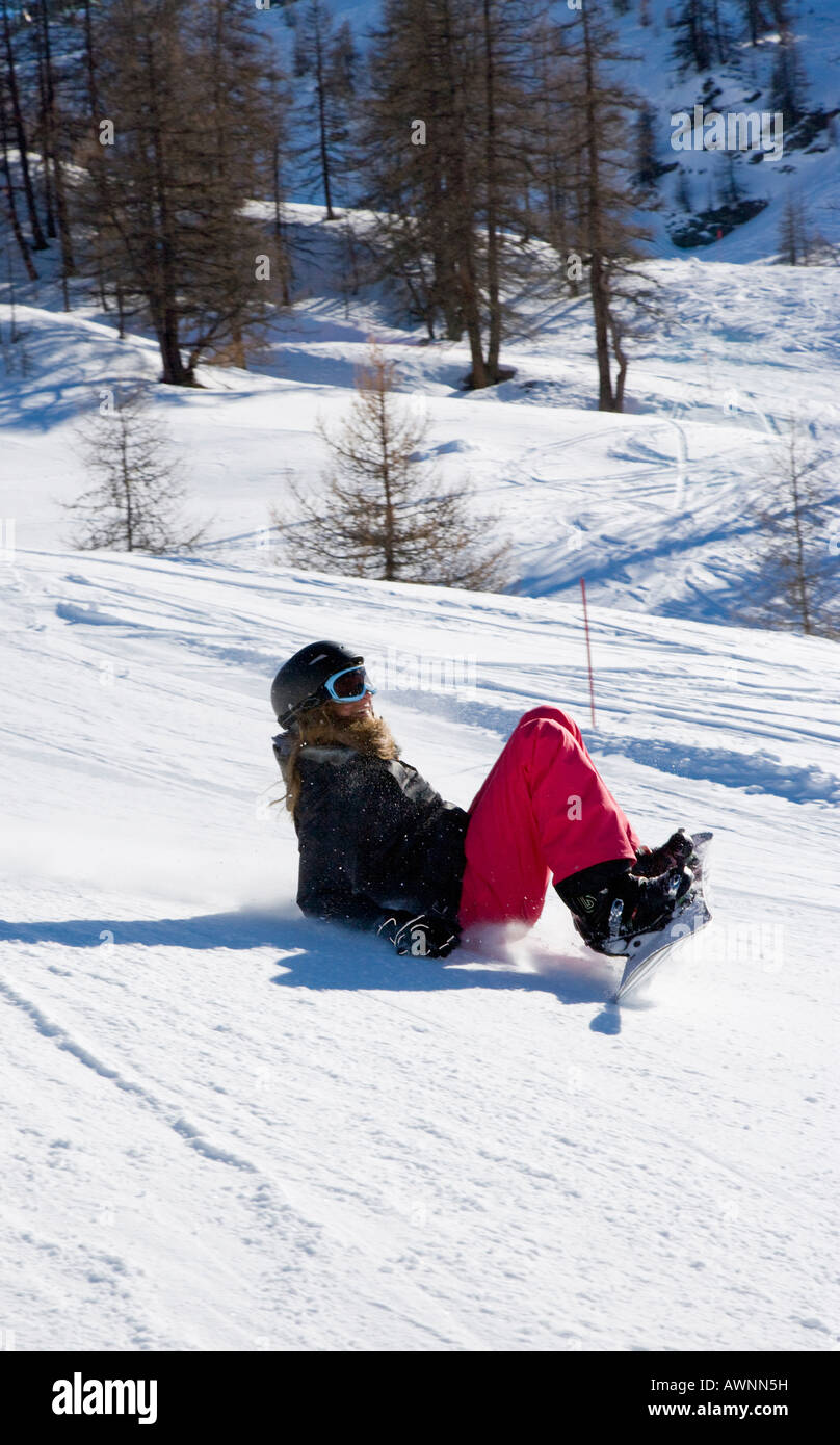 Fallen down female snowboarder smiling Via Lattea Piemonte Italy Stock ...