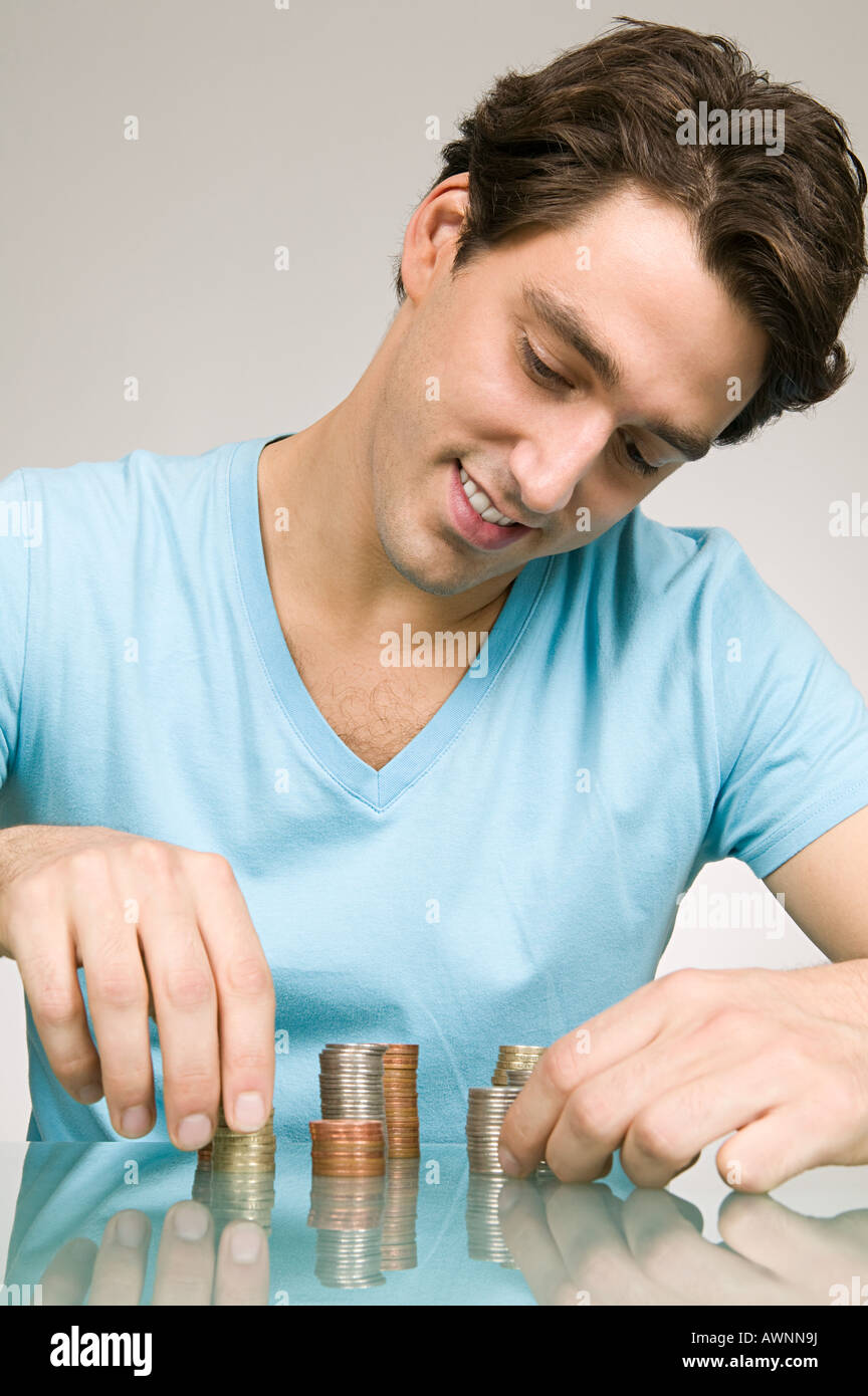 Man stacking coins Stock Photo - Alamy