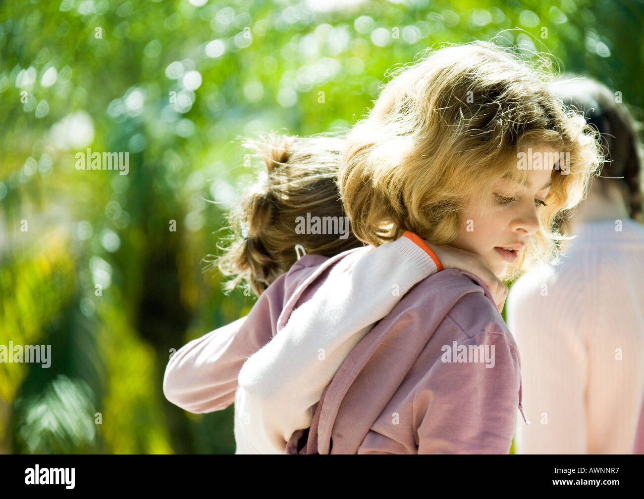 Girls with arms around each others' shoulders Stock Photo - Alamy