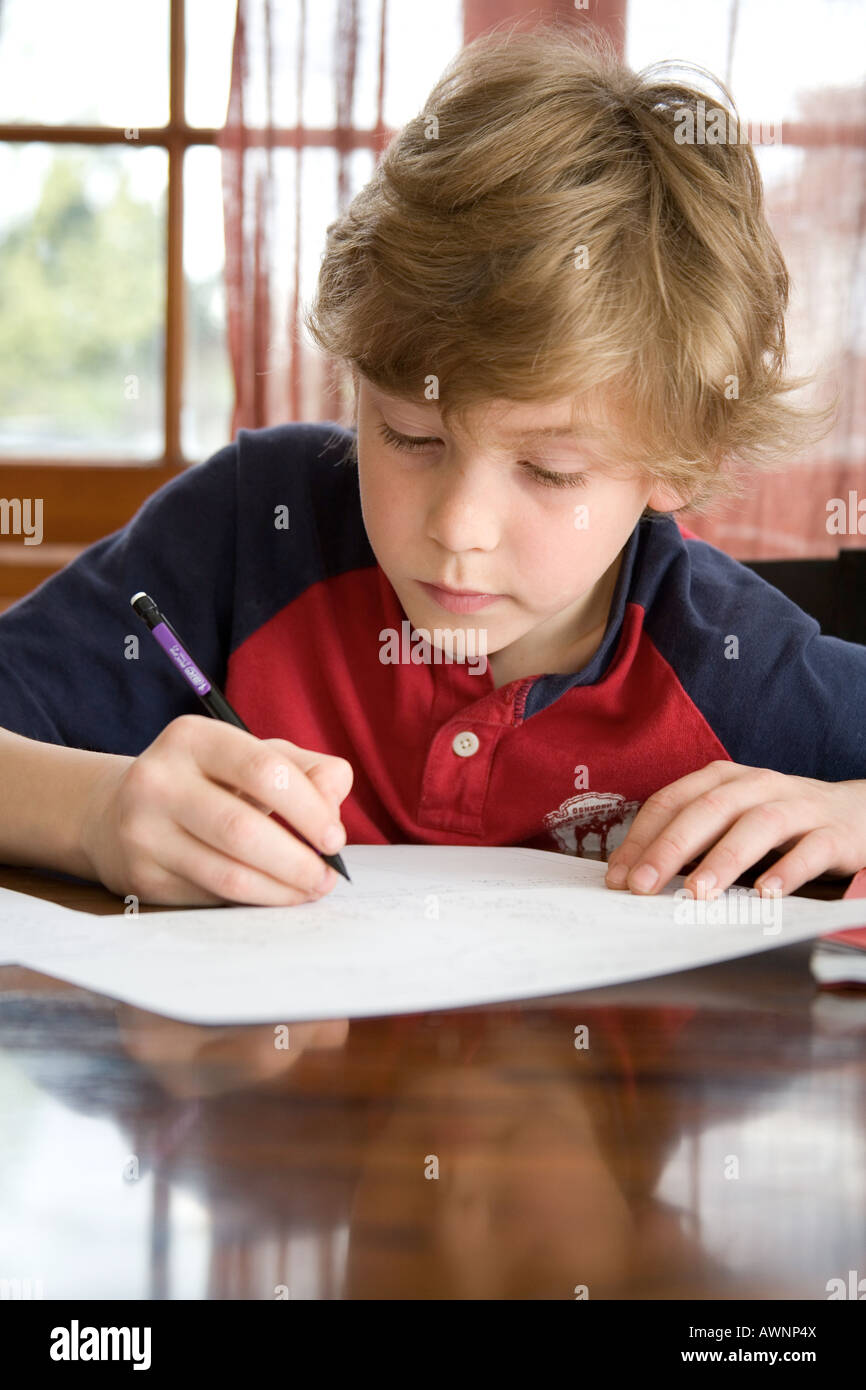 Eleven year old boy doing his homework Stock Photo - Alamy