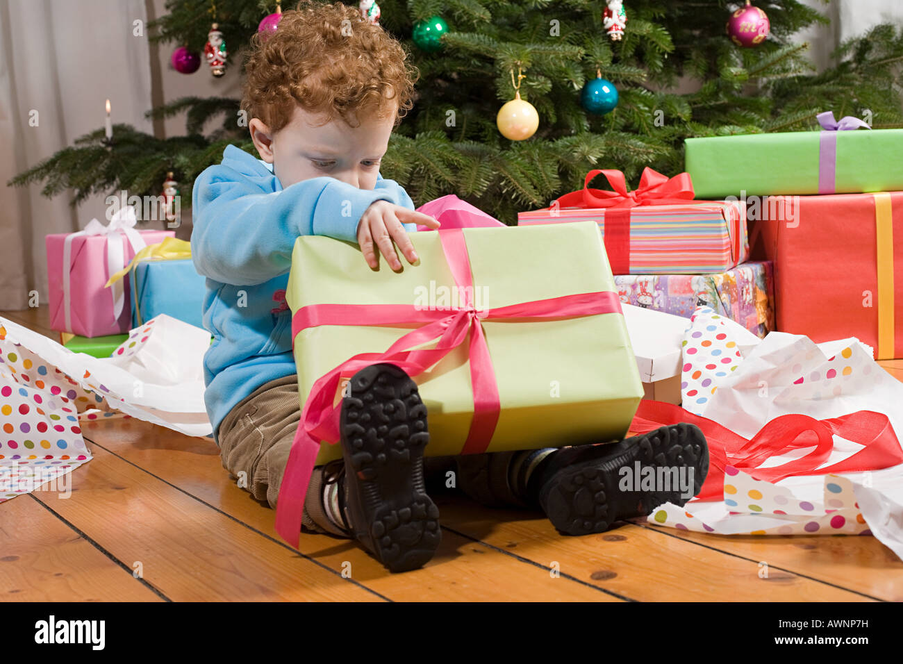 Boy opening christmas presents Stock Photo - Alamy
