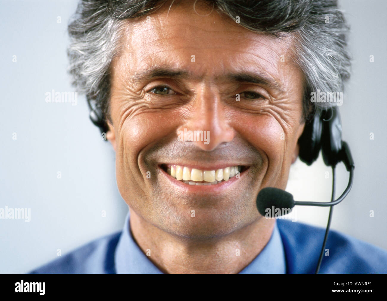 Man wearing headset, smiling at camera, close-up, portrait Stock Photo ...