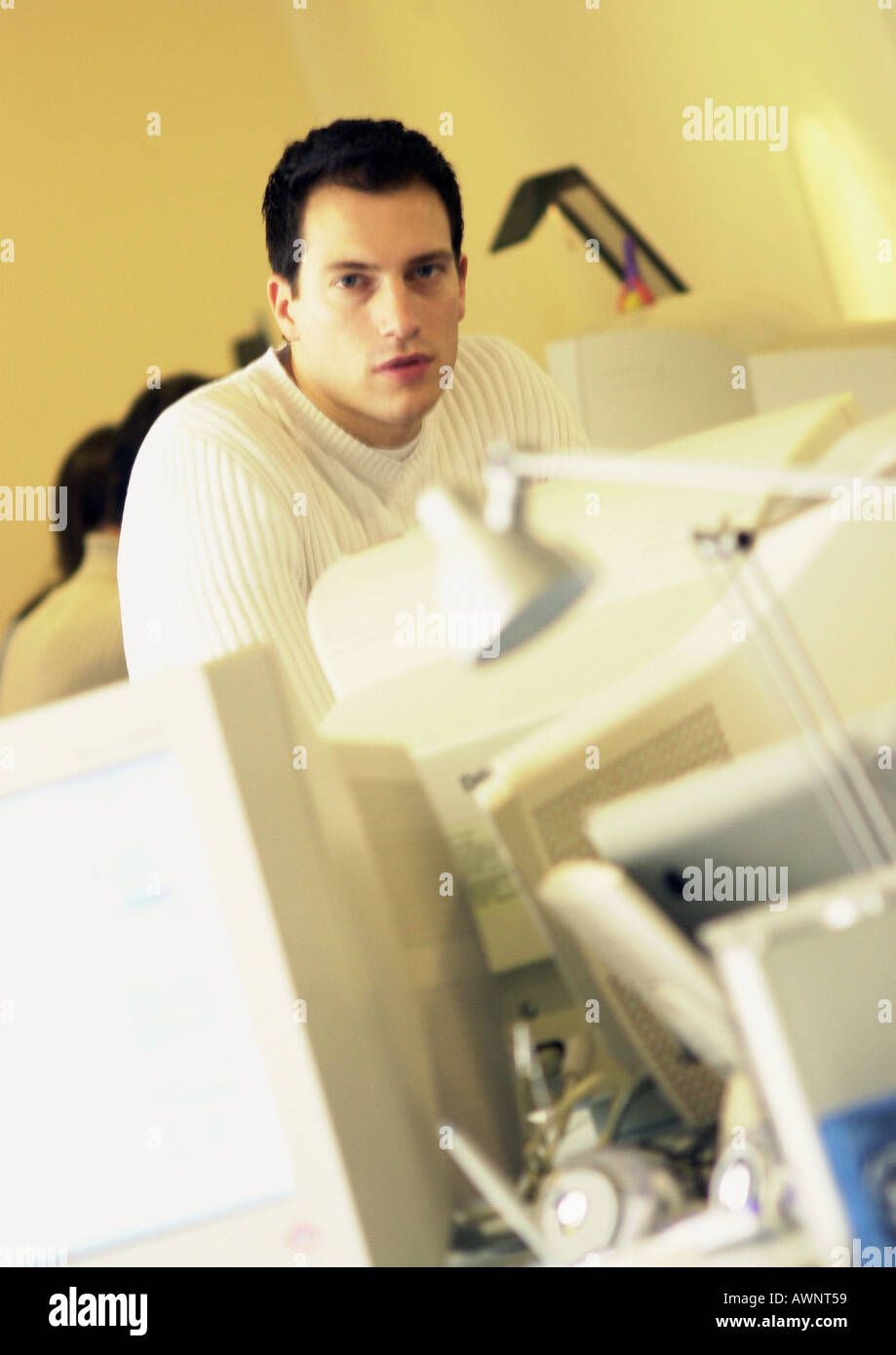 Man behind computers in office, portrait Stock Photo - Alamy