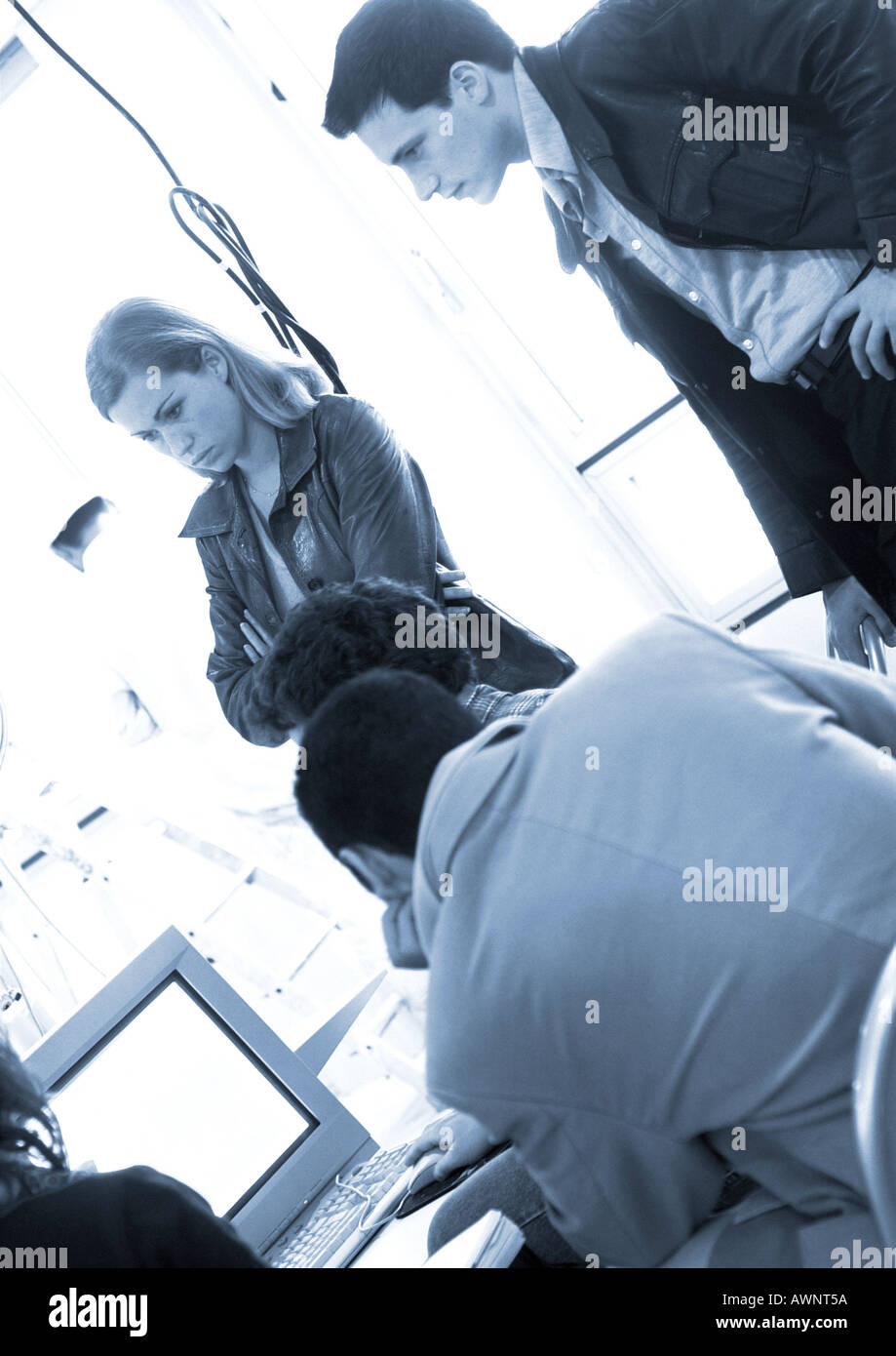 People standing around computer in hi-res stock photography and images ...