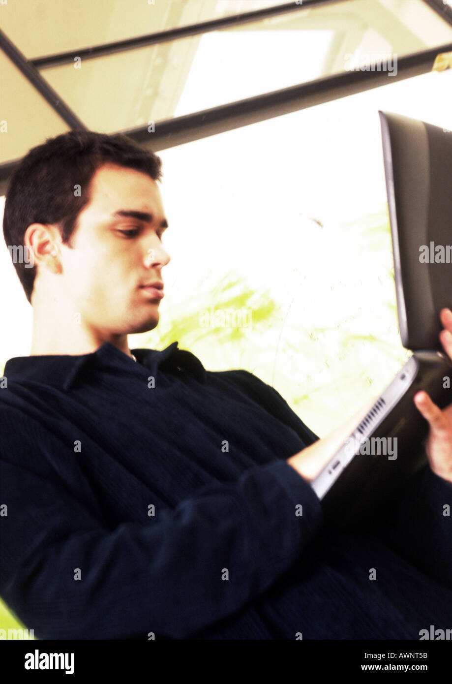 Man holding laptop computer Stock Photo - Alamy