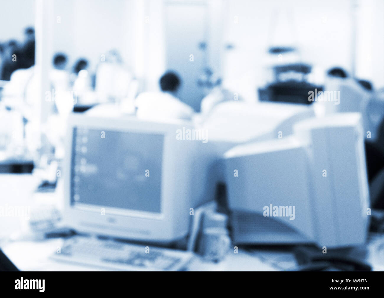 Computers in office, people working in background, blurred Stock Photo ...