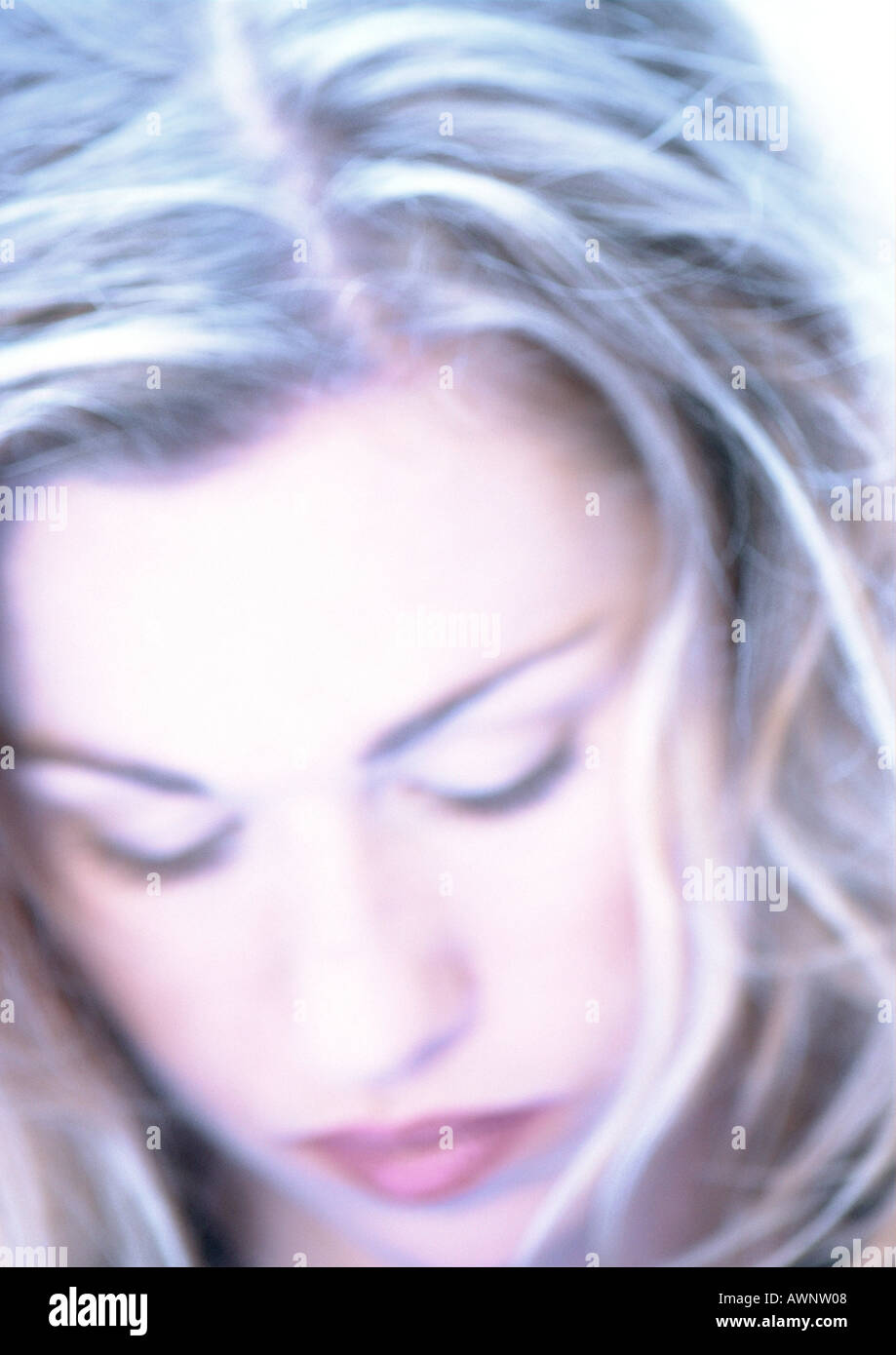 Woman's face with lowered eyes, close-up, blurred Stock Photo - Alamy