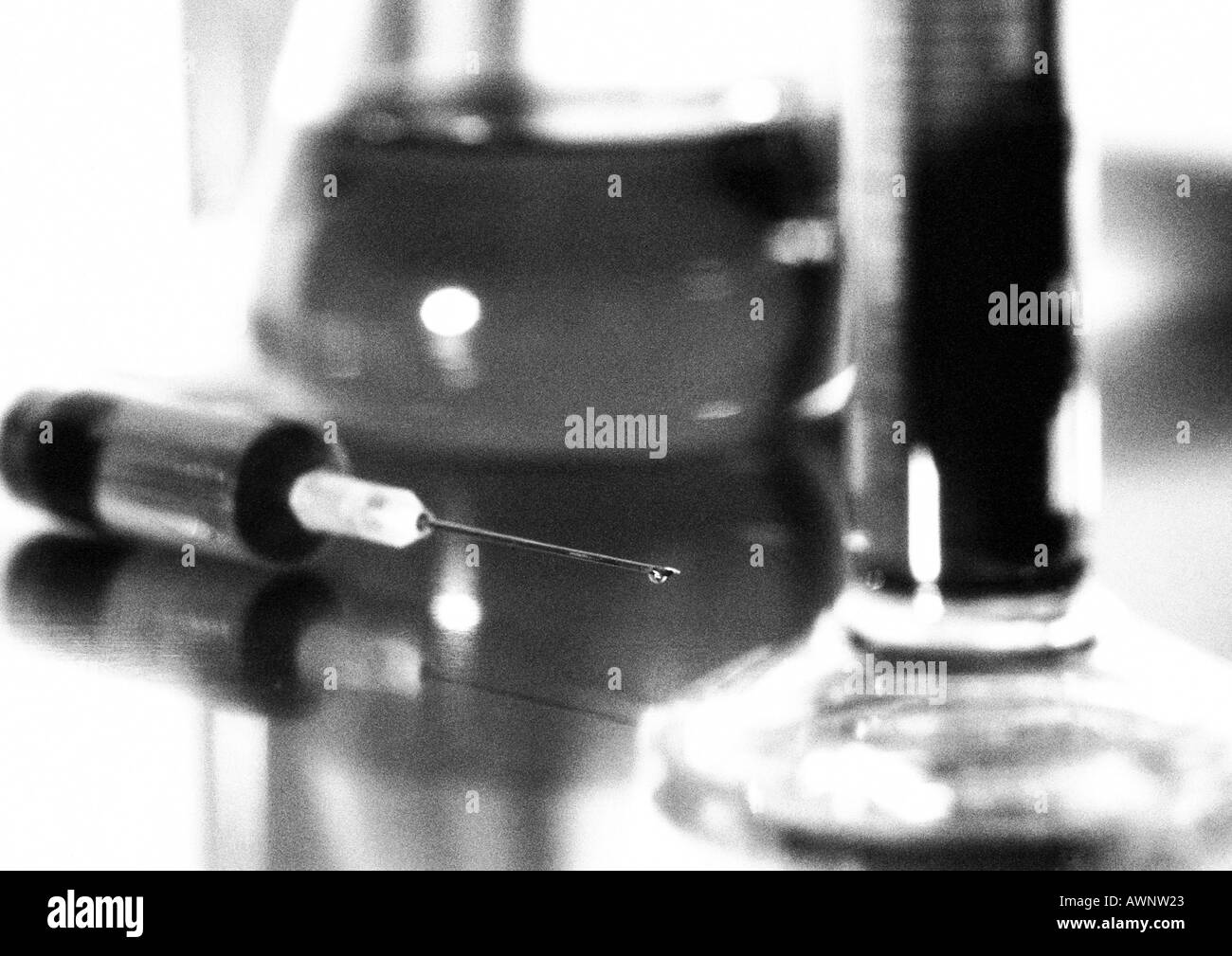 Syringe and laboratory glassware, close-up, b&w Stock Photo - Alamy