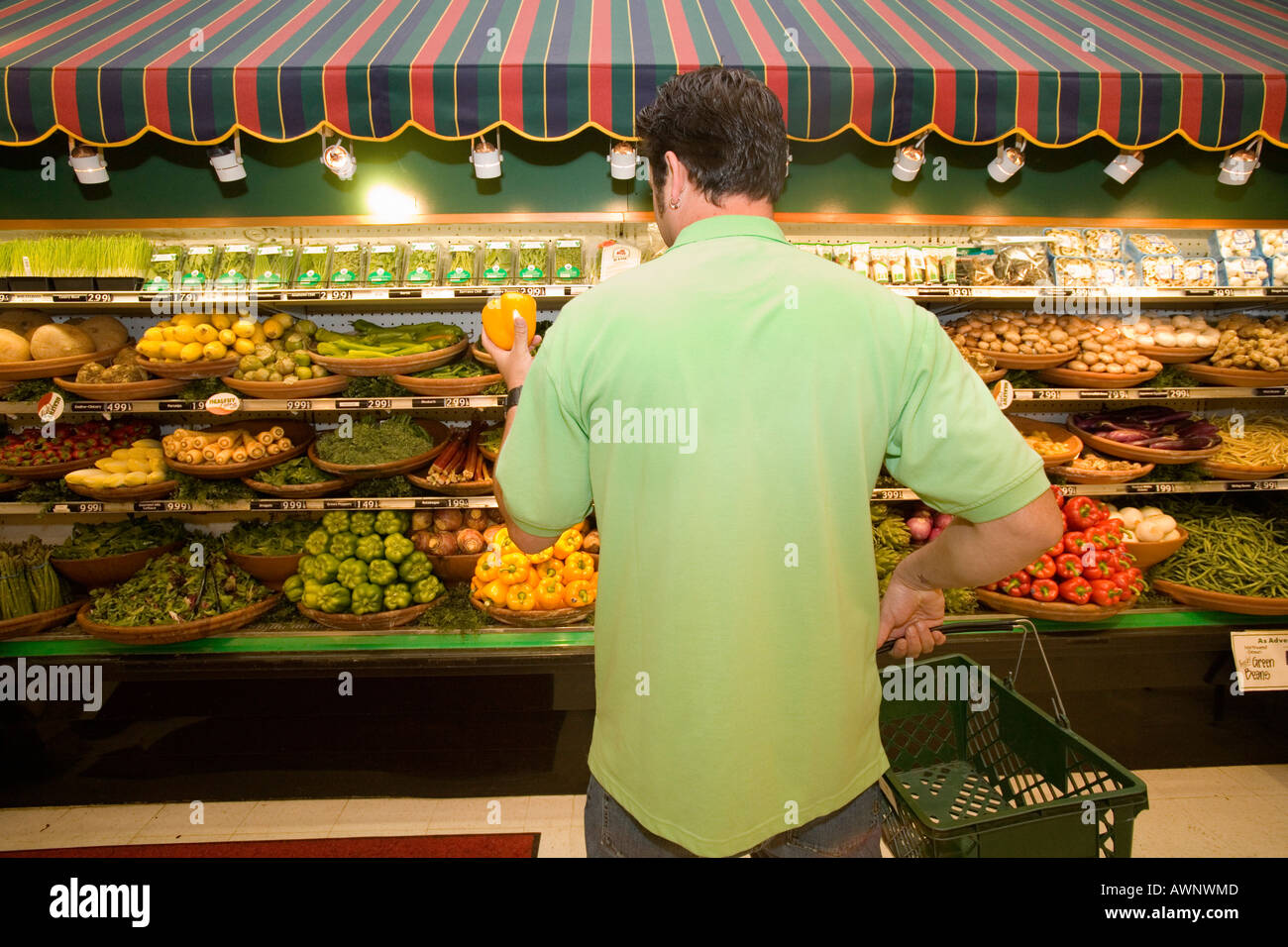 Man selecting produce in supermarket Stock Photo - Alamy