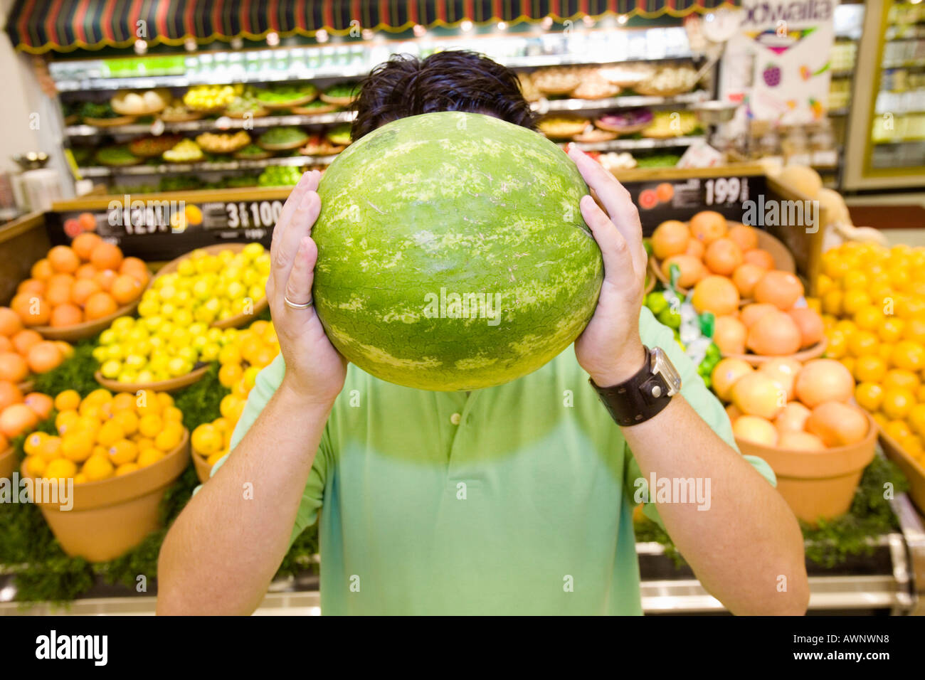 Man holding watermelon in supermarket Stock Photo - Alamy