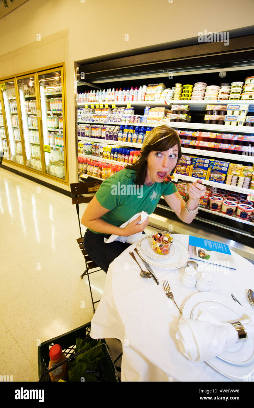 Woman eating dinner in grocery store Stock Photo - Alamy