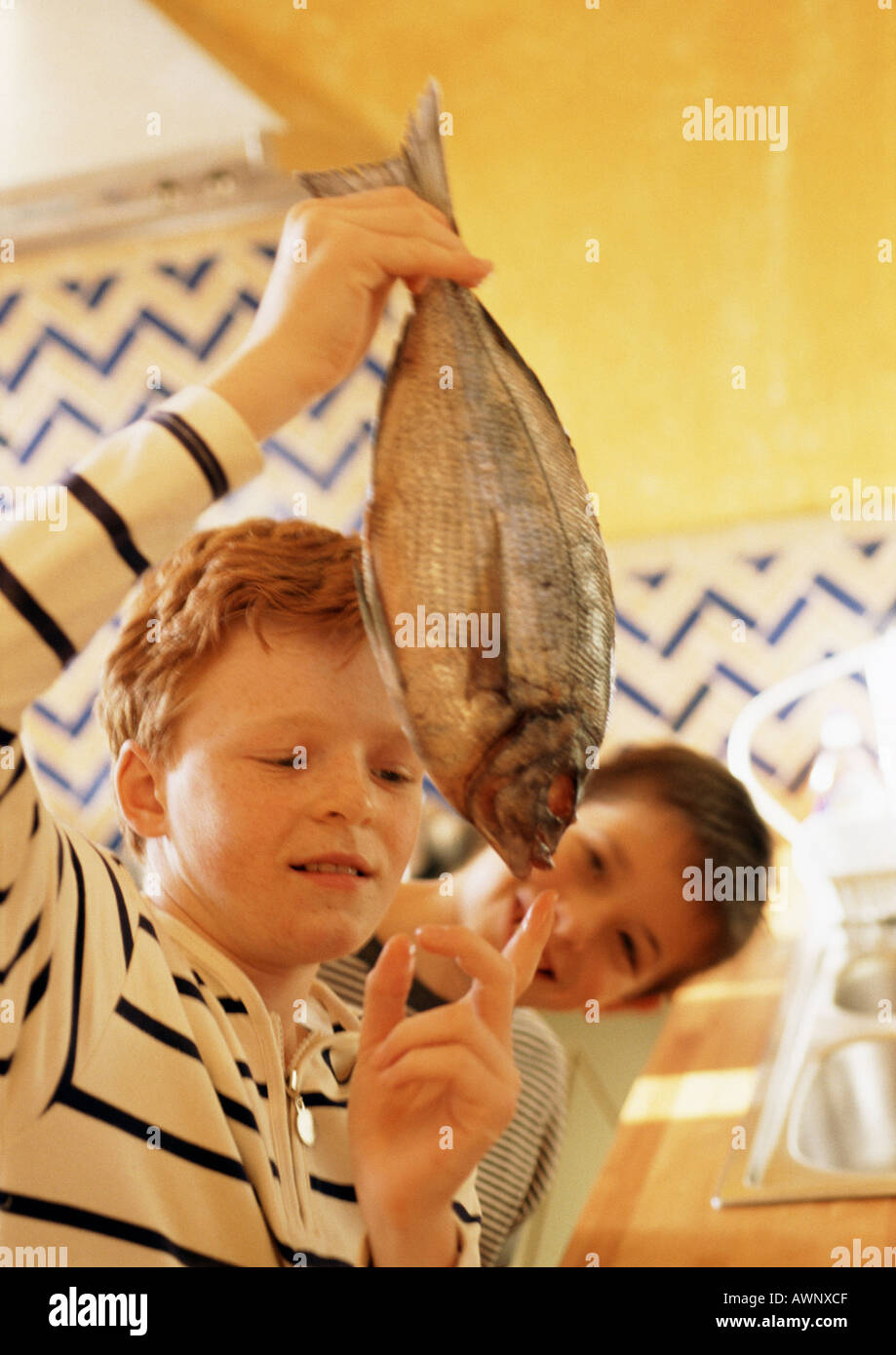 Two boys holding two fish hi-res stock photography and images - Alamy