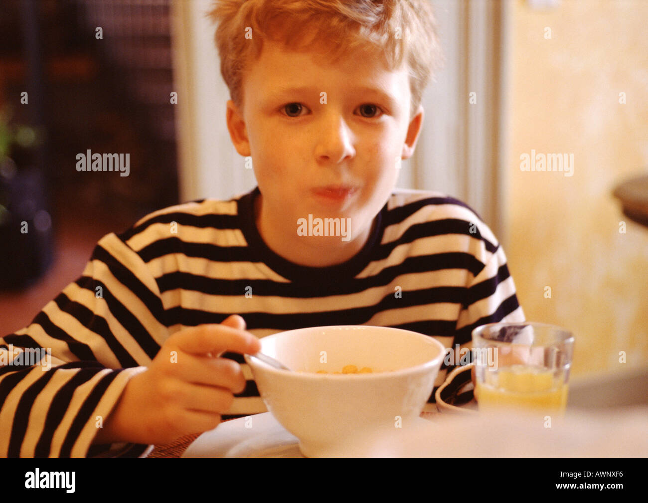 Child eating cereal, looking at camera, portrait Stock Photo - Alamy