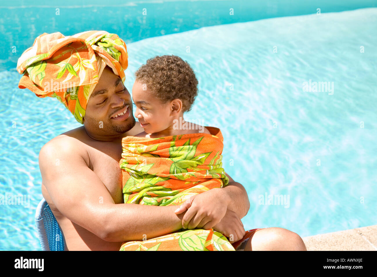Father and son drying off by pool Stock Photo - Alamy