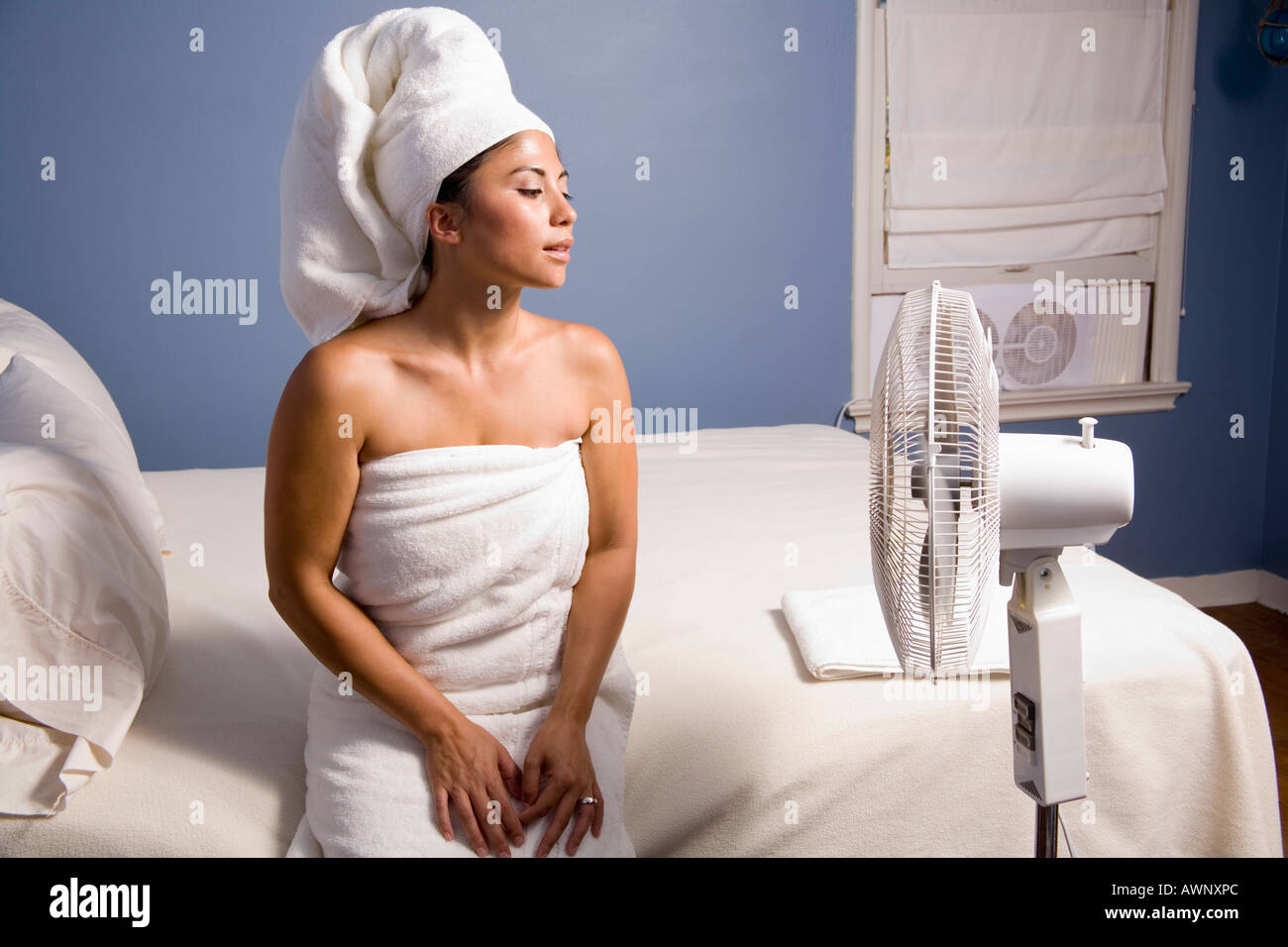 Woman drying off with a fan Stock Photo - Alamy