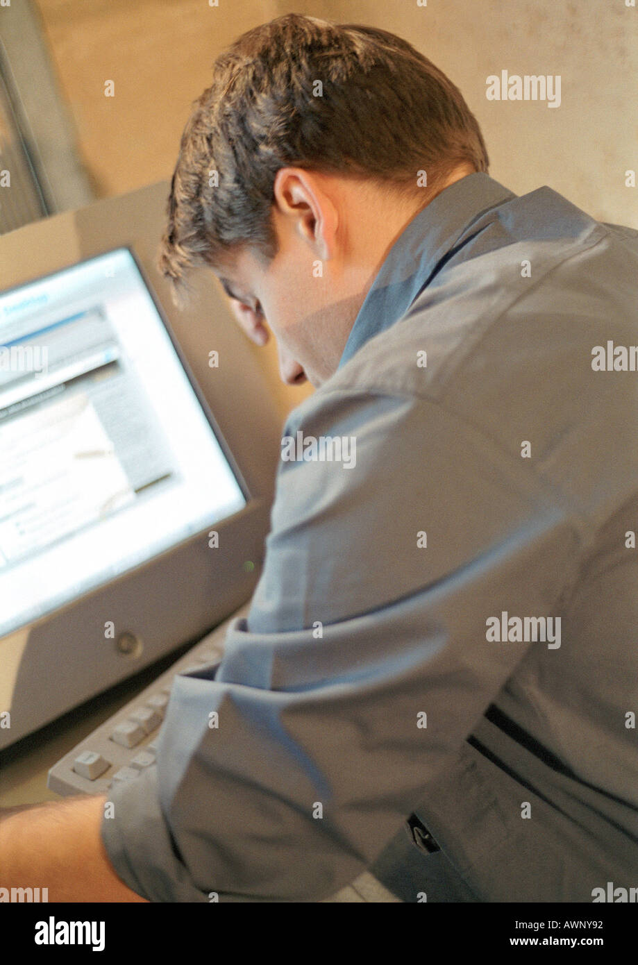 Man working on computer, rear view Stock Photo - Alamy