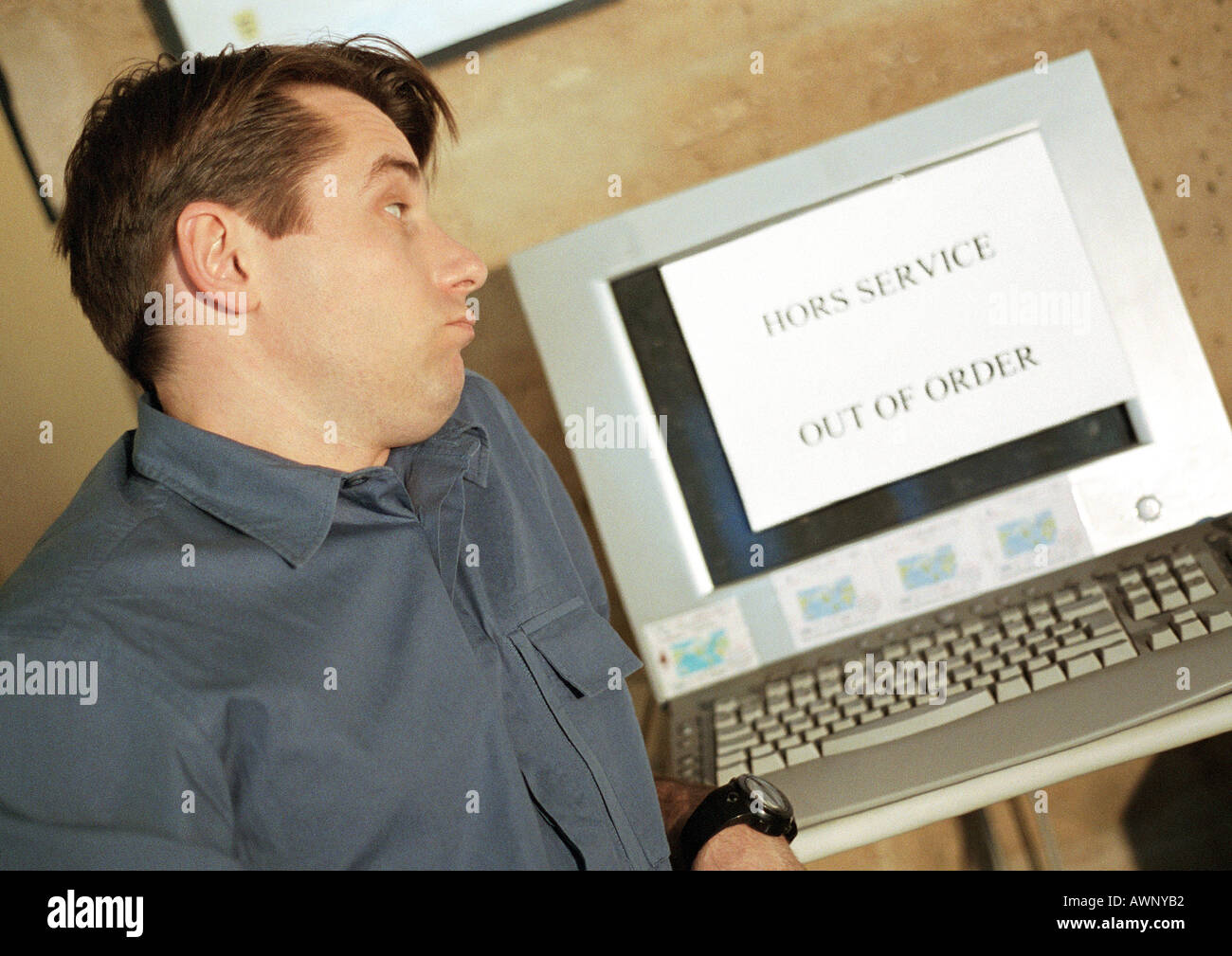 Man looking at computer screen with "out of order" sign on screen Stock ...