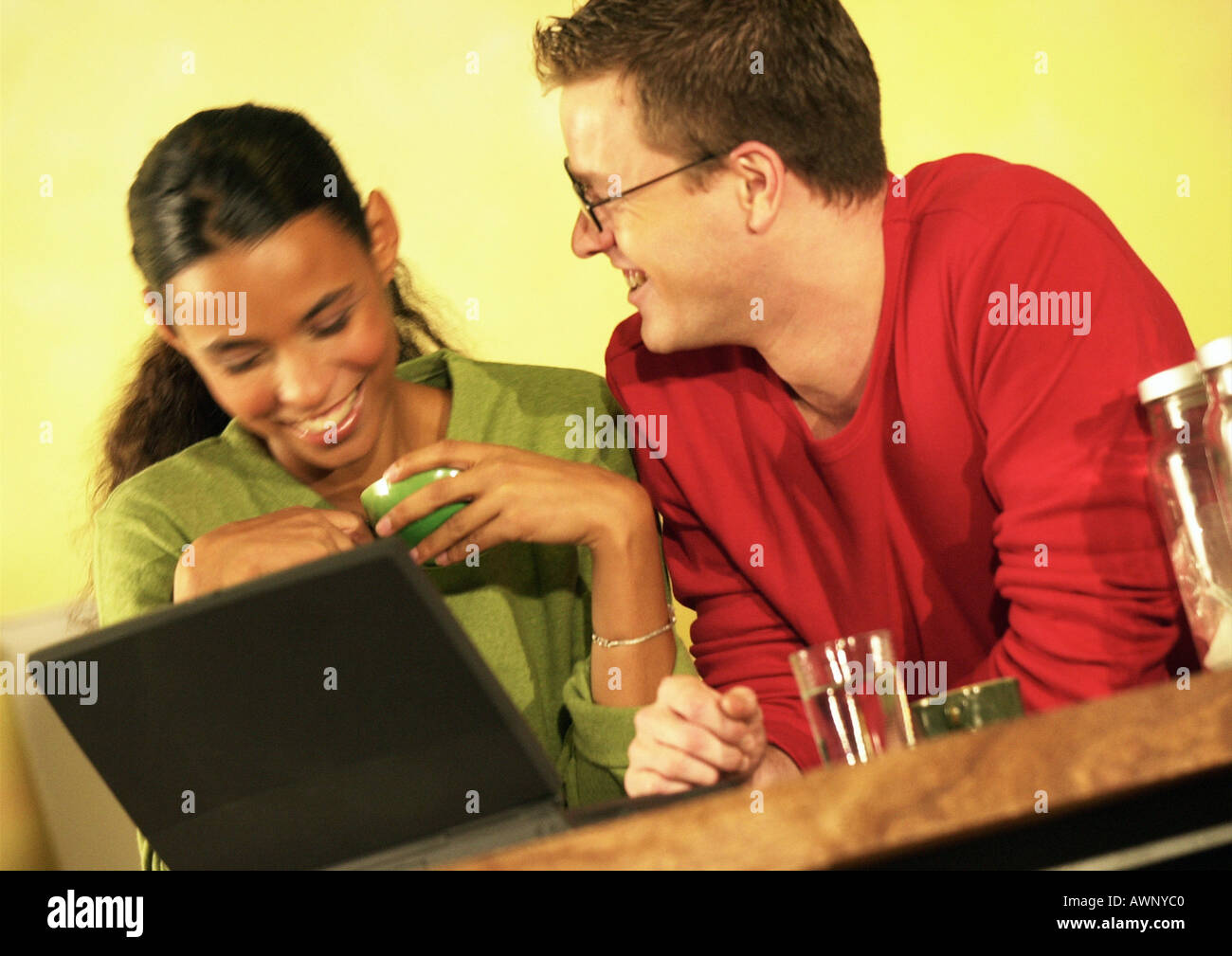 Man and woman with laptop computer, smiling Stock Photo - Alamy