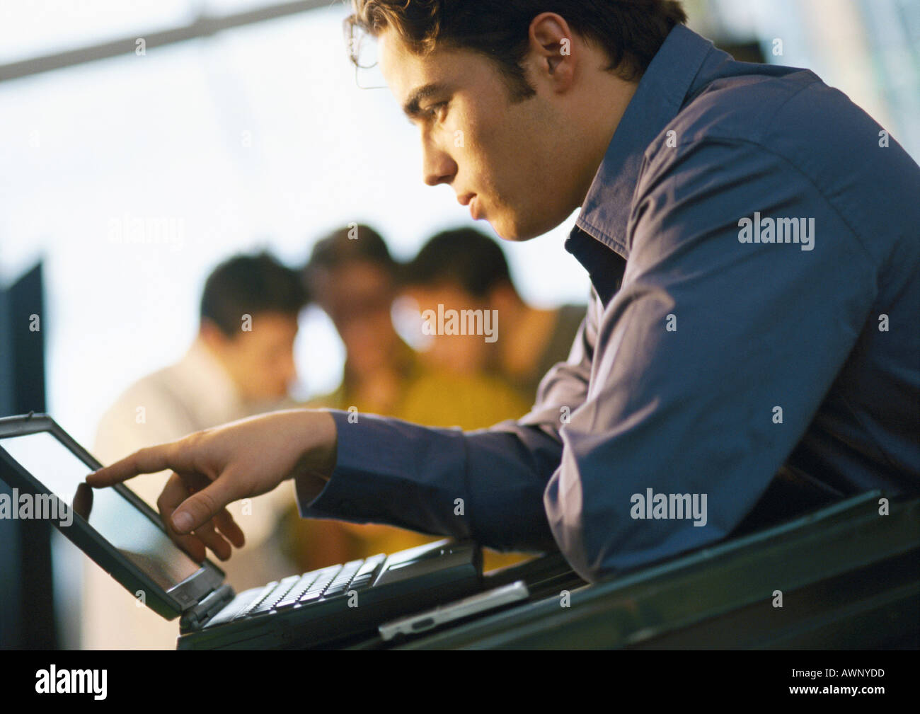 Man looking at laptop computer, side view Stock Photo - Alamy