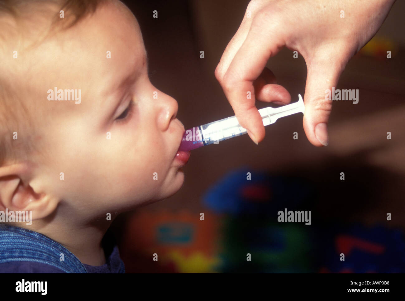 BABY BOY RECEIVING MEDICINE FROM SYRINGE Stock Photo - Alamy