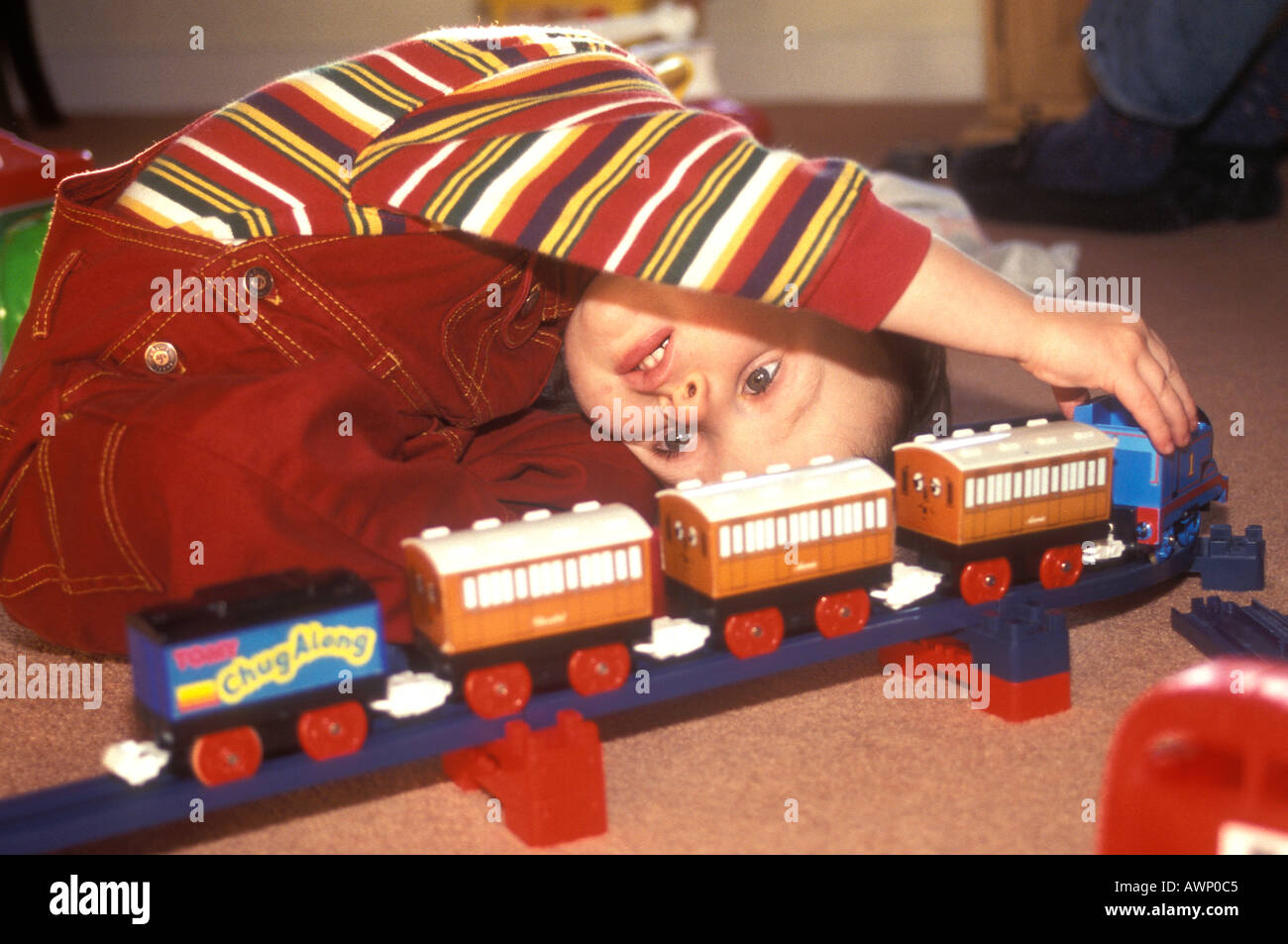 BABY BOY PLAYING WITH TRAIN SET Stock Photo - Alamy