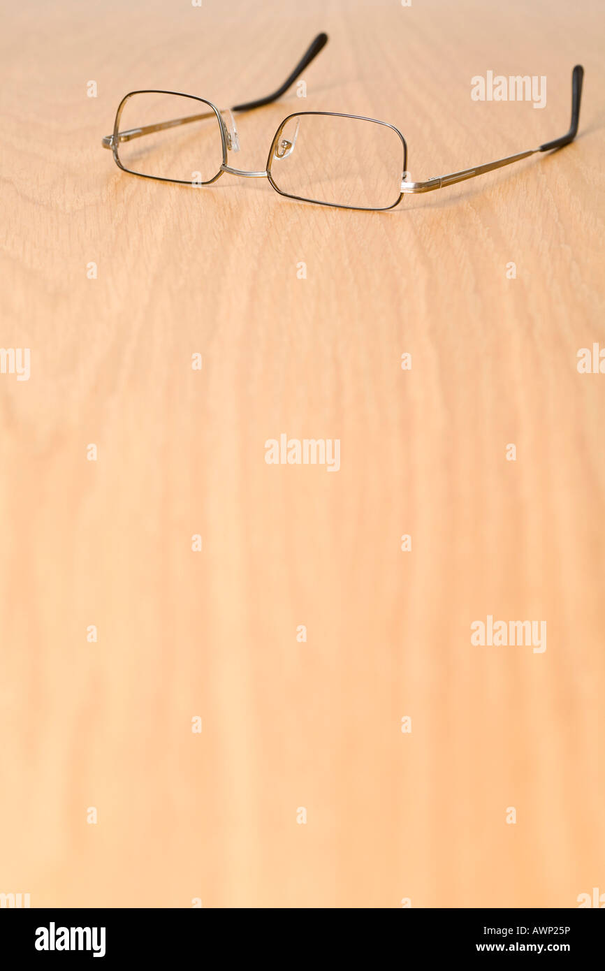 Eyeglasses on a desk Stock Photo - Alamy