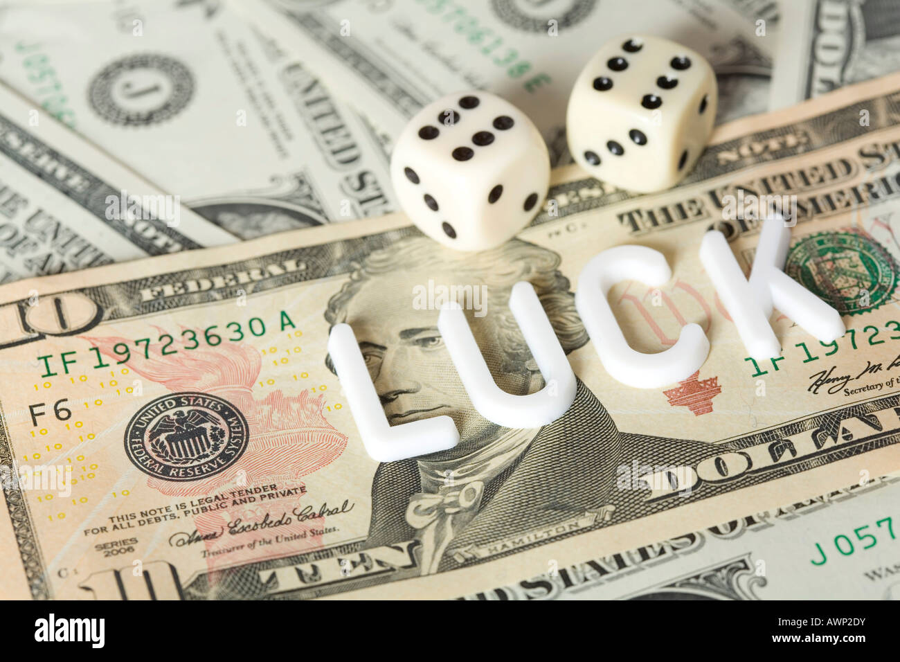 Dice on cash with "luck" lettering Stock Photo - Alamy