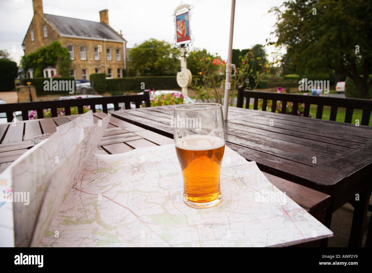 Pint of beer and map on outdoor table, Gloucestershire, United Kingdom ...