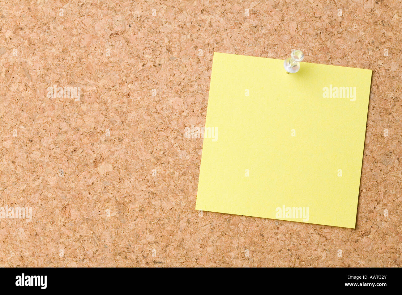 Yellow post-it note stuck to a bulletin board (pin board Stock Photo ...