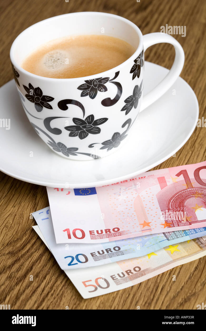 Cash (Euros) beside a cup of coffee Stock Photo - Alamy