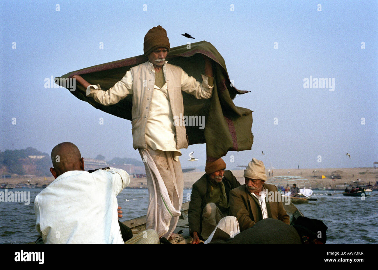 A group of Hindu pilgrims take a boat to the sacred Sangam, a Hindu ...