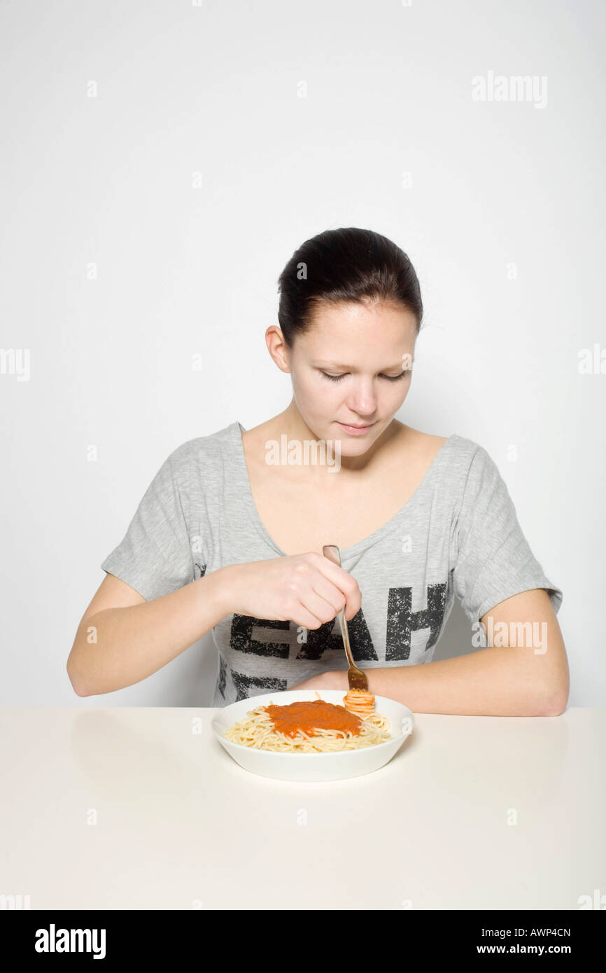 Young woman eating spaghetti Stock Photo - Alamy