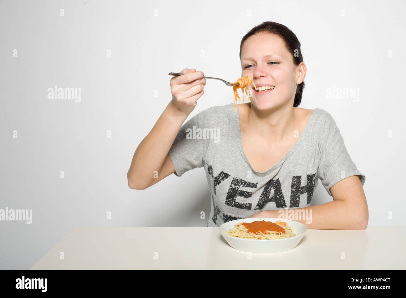 Young woman eating spaghetti Stock Photo - Alamy