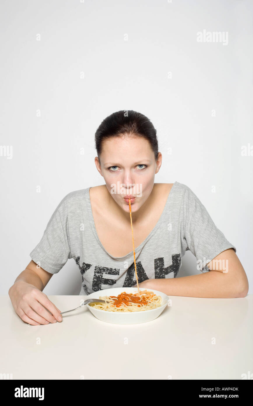 Young woman eating spaghetti Stock Photo - Alamy