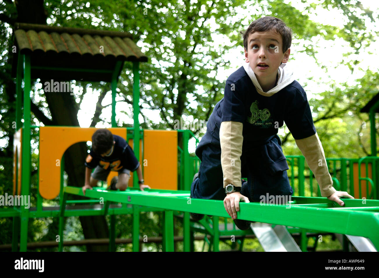 Two boys on a climbing frame Stock Photo - Alamy