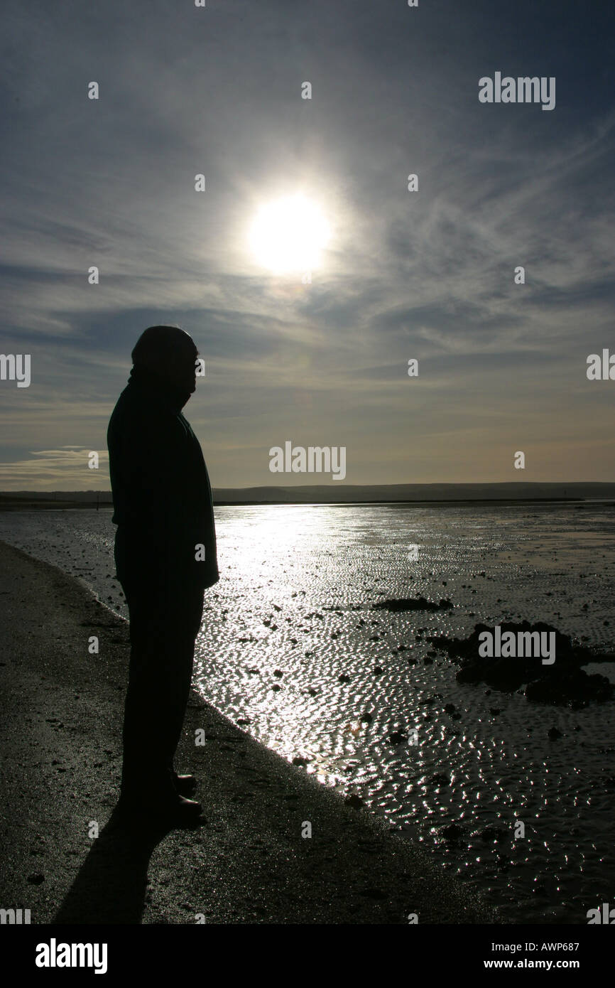 silhouetted man on beach Stock Photo - Alamy